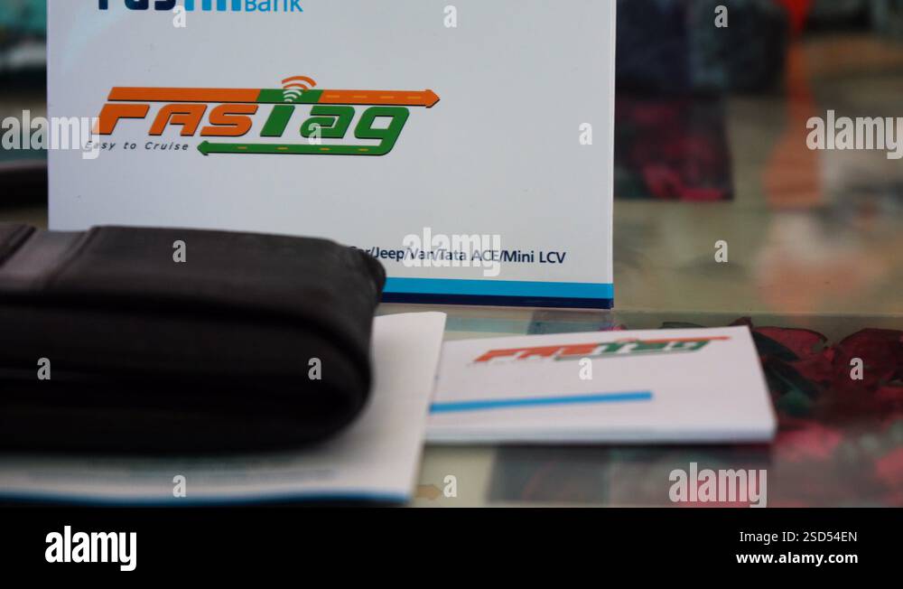 Panning shot of a new FASTag RFID sticker with the envelope, a wallet ...