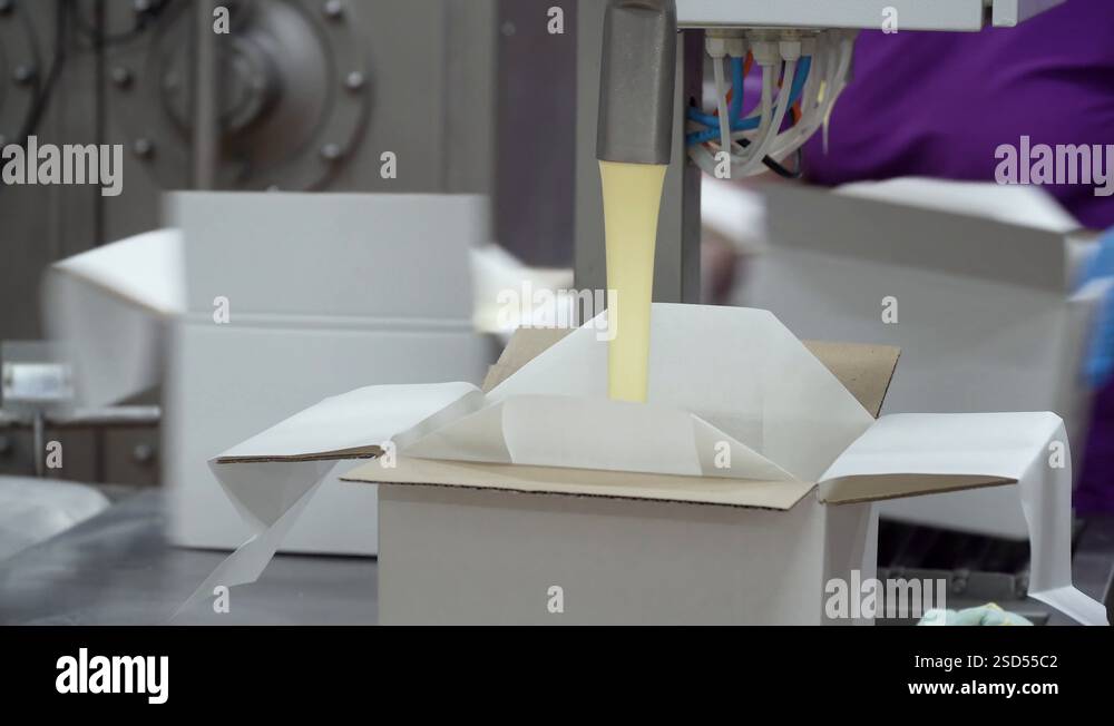 The process of packing the oil or spread into the box. The machine puts ...