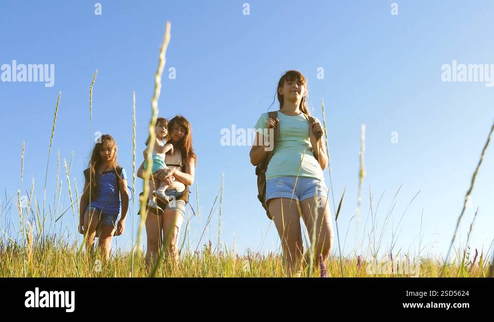 Teamwork travelers. Happy mom and daughters, a little baby travel ...