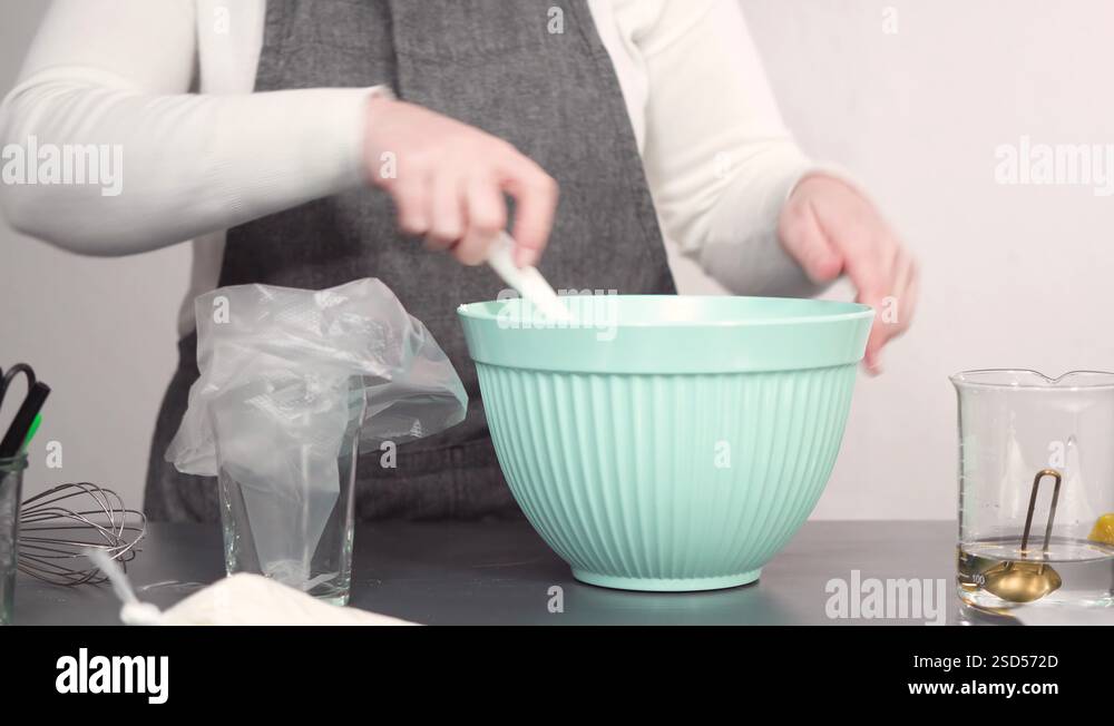 Mixing in food coloring into the royal icing to decorate sugar cookies ...