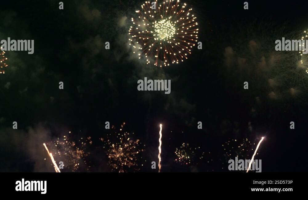 4k. Golden big shiny fireworks with bokeh lights in the night sky Stock ...