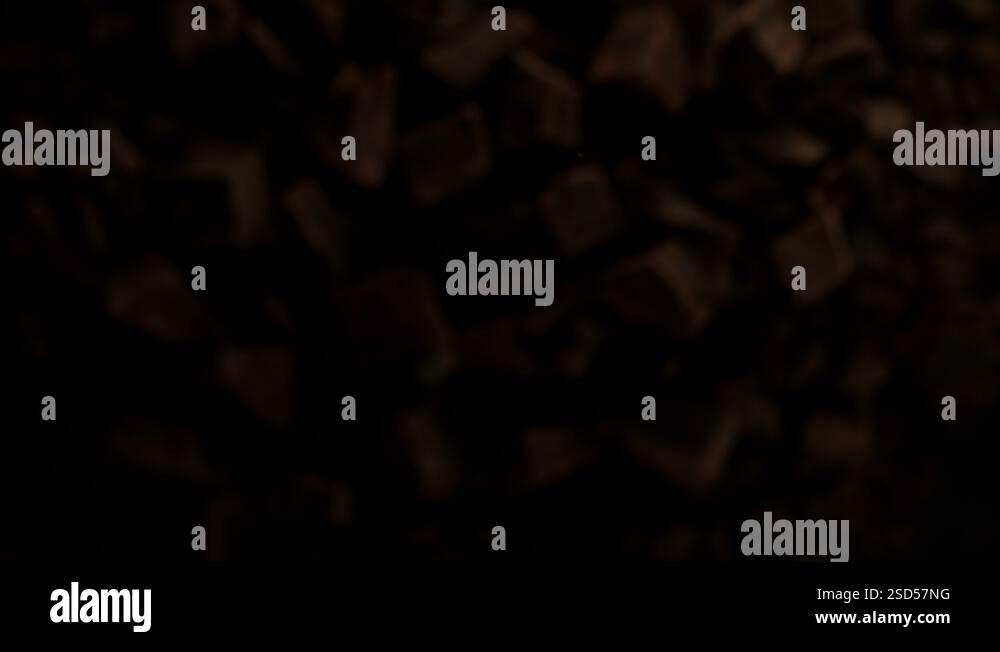 Super Slow Motion Shot of Raw Chocolate Chunks and Cocoa Powder after ...