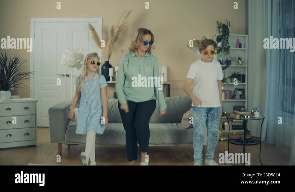 Grandparents are dancing with grandchildren in the living room Stock ...
