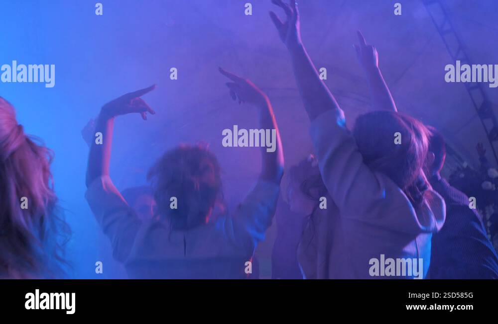 People dance, jump and raise their hands in smoke Stock Video Footage ...