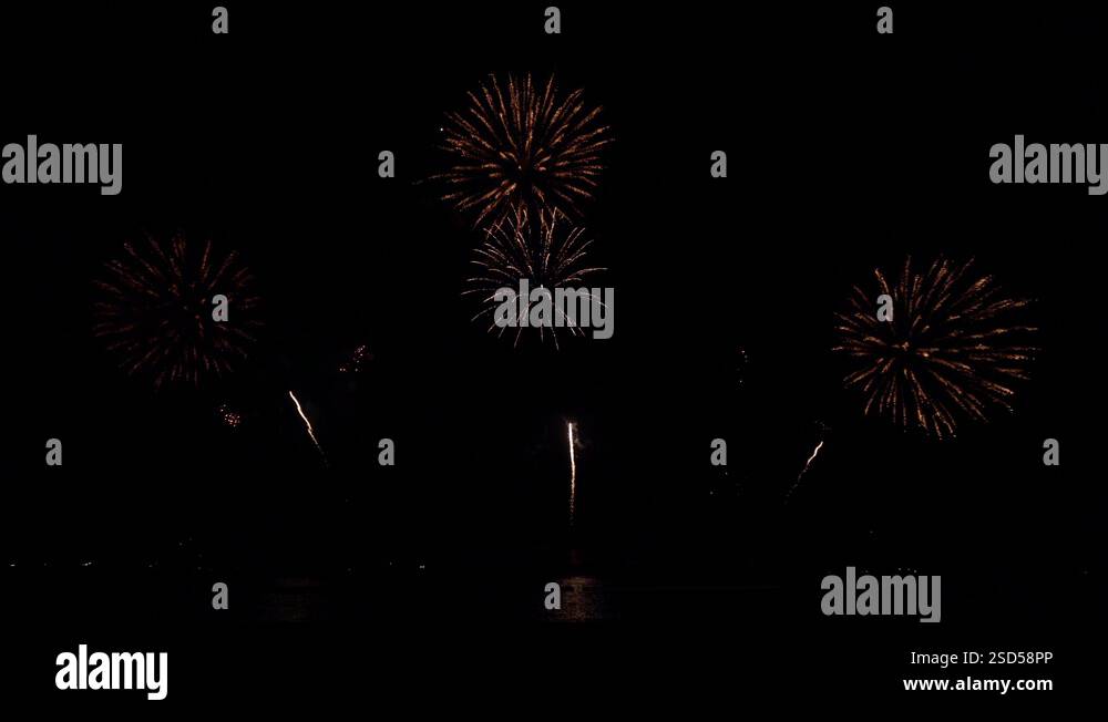 4k. Golden big shiny fireworks with bokeh lights in the night sky Stock ...