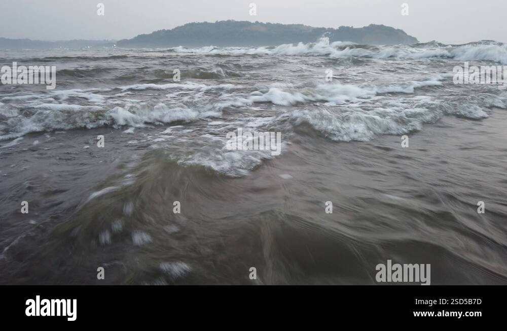 Foamy sea waves on shore. Foamy waves of clean sea water rolling on wet ...