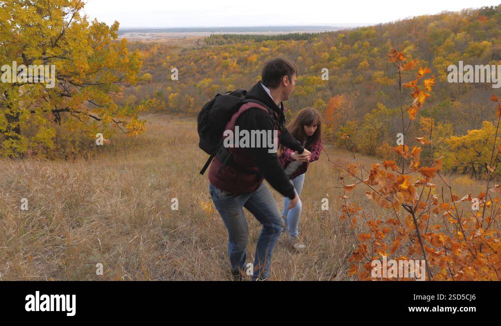 teamwork of tourists. Climbers help a friend rise by holding out a ...