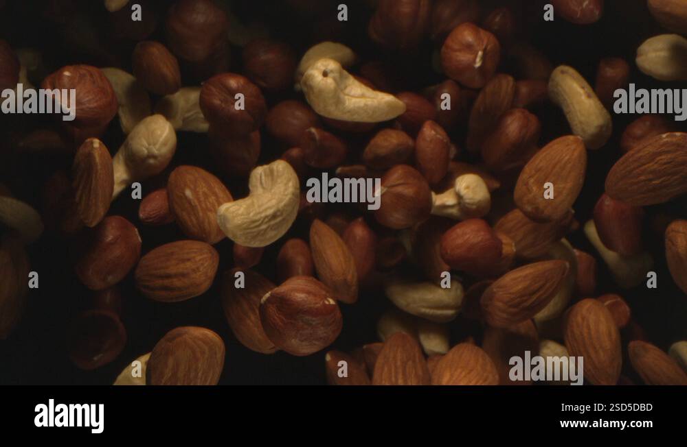 Assorted Nuts Flying in the Air in a Free Fall in Slow Motion on Black ...