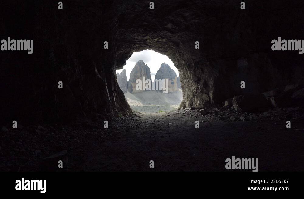Dark empty Mountain Cave with view on the Dolomites Alps Tre Cime di ...