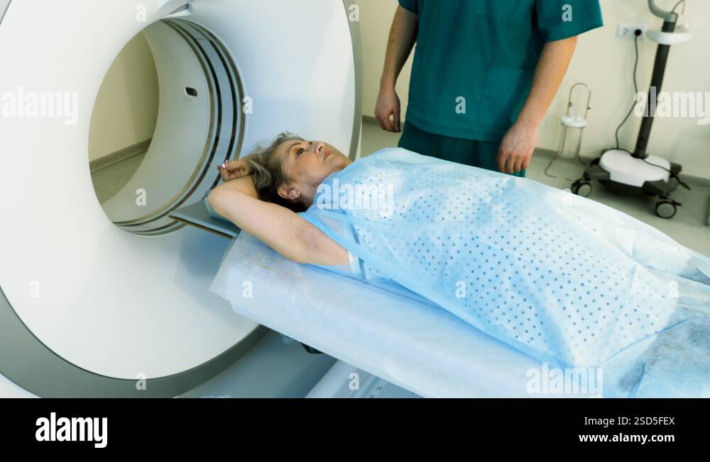 Aged female patient on CT or MRI scanner with doctor in hospital. 4K Stock Video Footage - Alamy