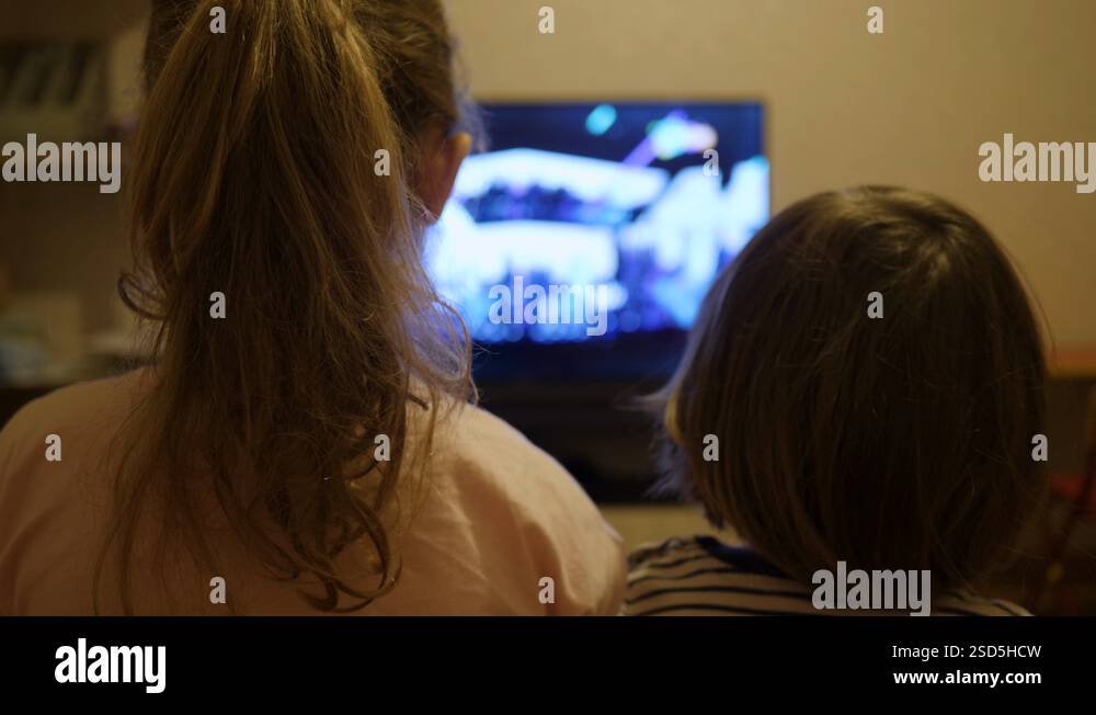 Little Kids While Watching TV. Children Watch Television on Living Room ...