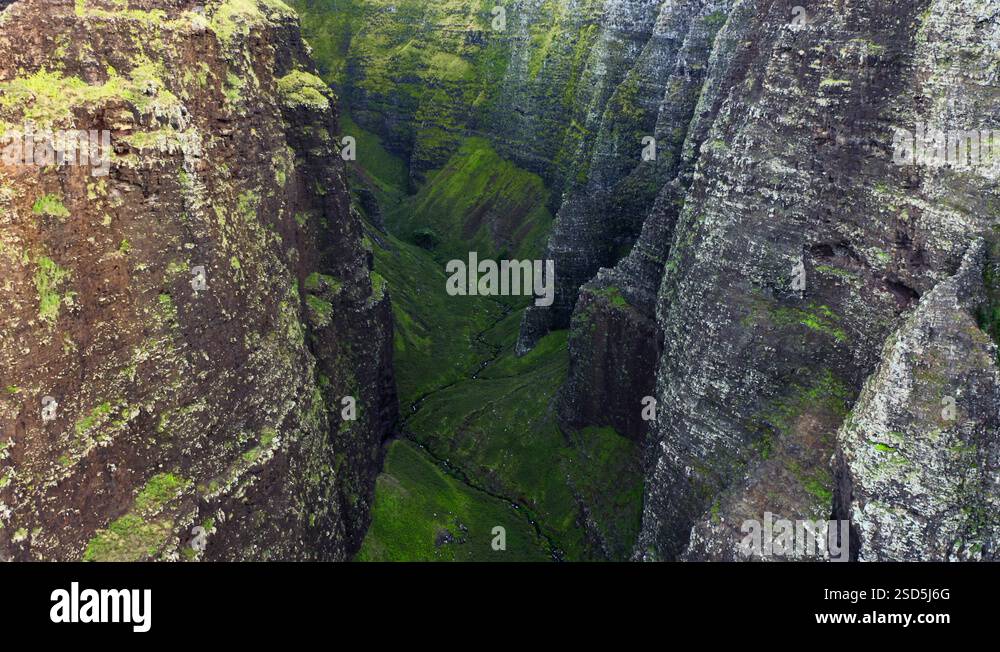 Drone survey from the wild deep ravine of Hawaii massif. Rocky volcanic ...