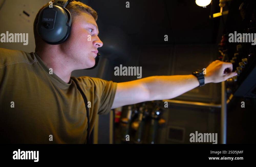 KC-10 Extender boom operator adjusting controls during aerial refueling ...