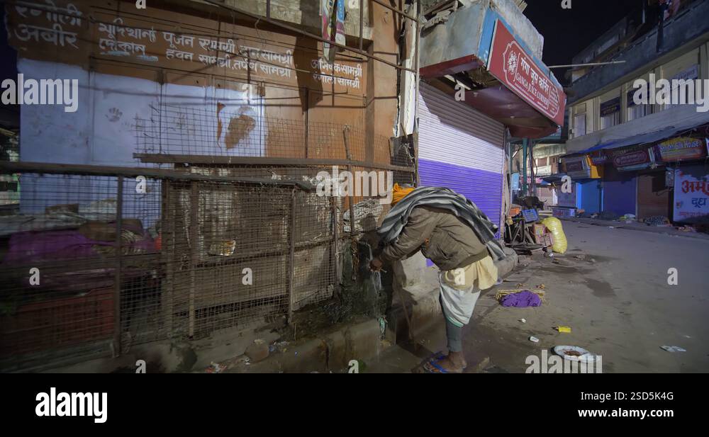 homeless man living in streets of Varanasi washing his face, India ...
