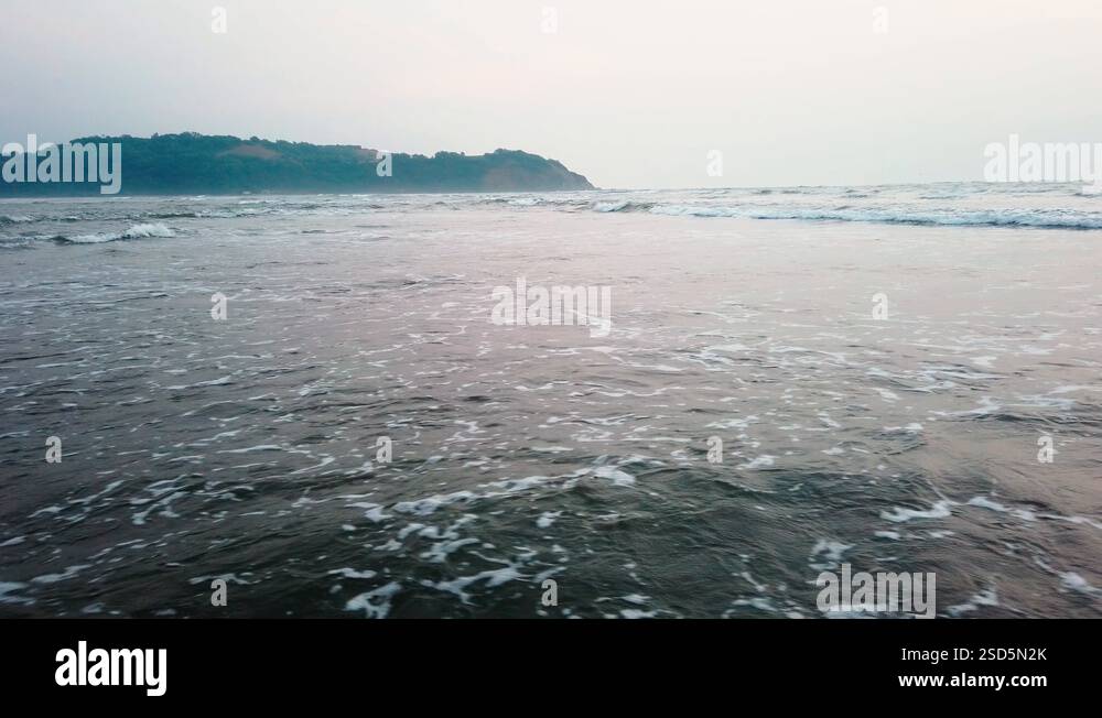 Foamy sea waves on shore. Foamy waves of clean sea water rolling on wet ...