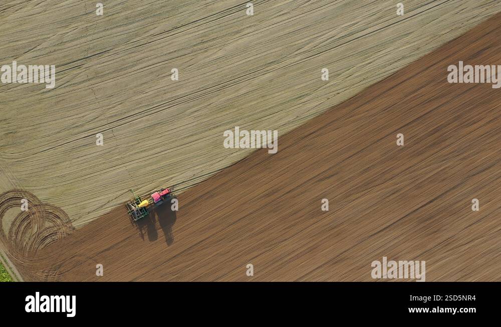 Tractor Plowing And Planting Seeds Of Grain Crops In Rural Field Aerial ...