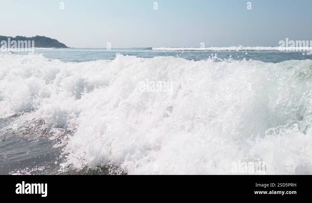 Foamy sea waves on shore. Foamy waves of clean sea water rolling on wet ...