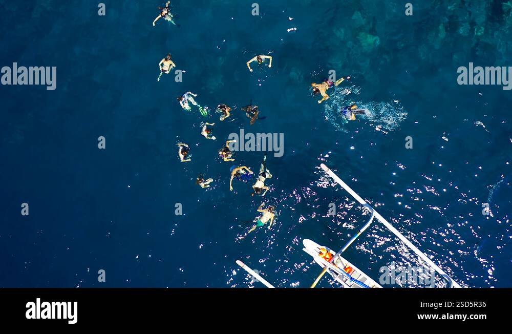 Tourist people snorkeling and scubadiving in azure sea at the Jemeluk ...