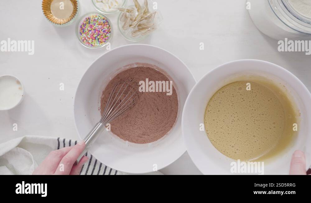 Mixing ingredients together in a white mixing bowl Stock Video Footage ...