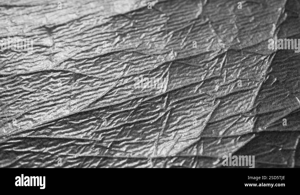Silver crumpled surface of shabby wrapping material with wrinkles and ...