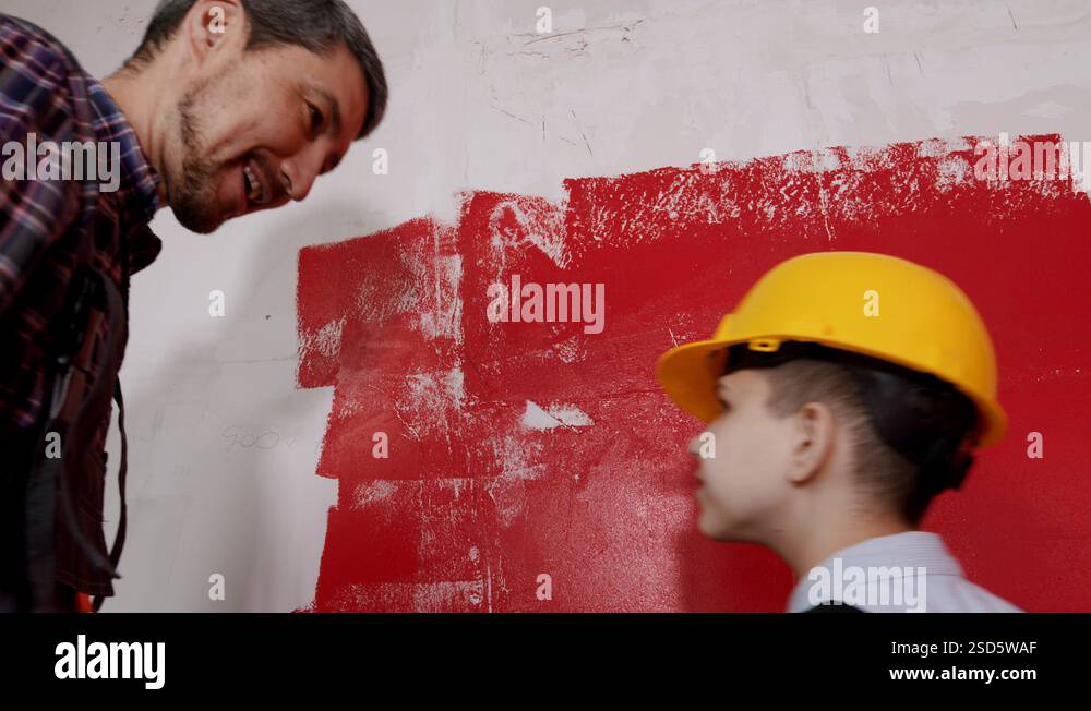 Family repair a draft apartment - little boy and his father painting ...