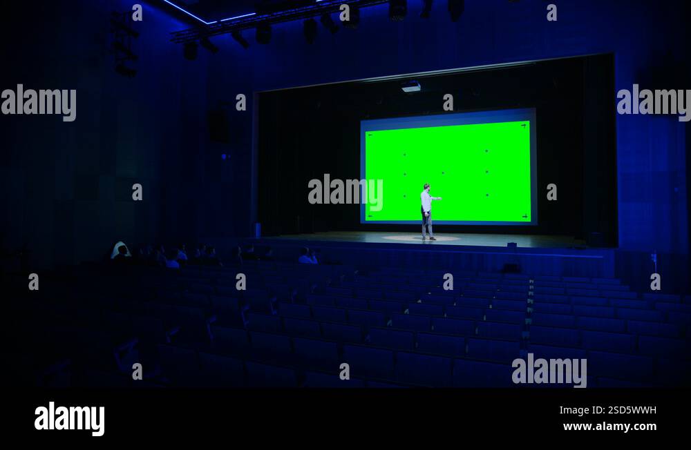 Speaker Does Presentation of New Product to Audience, Behind Him Green ...