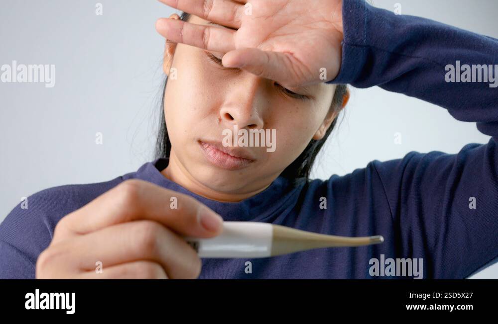 A Woman have a fever and measuring temperature her body by digital ...