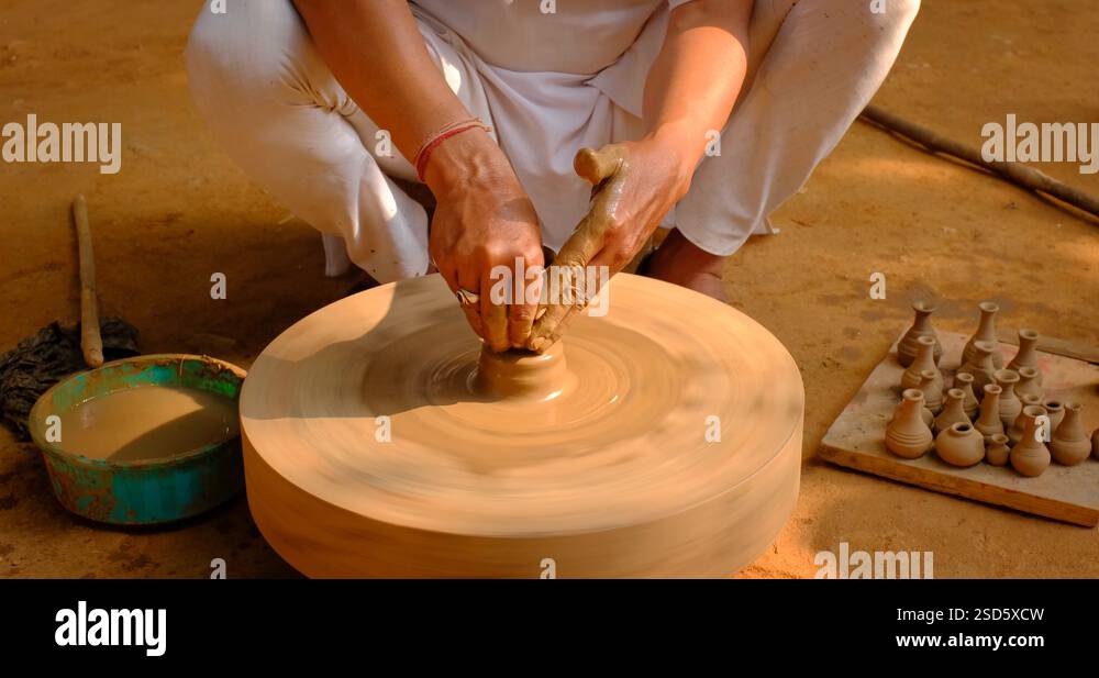 Skilled hands of potter shaping the clay on potter wheel and sculpting ...