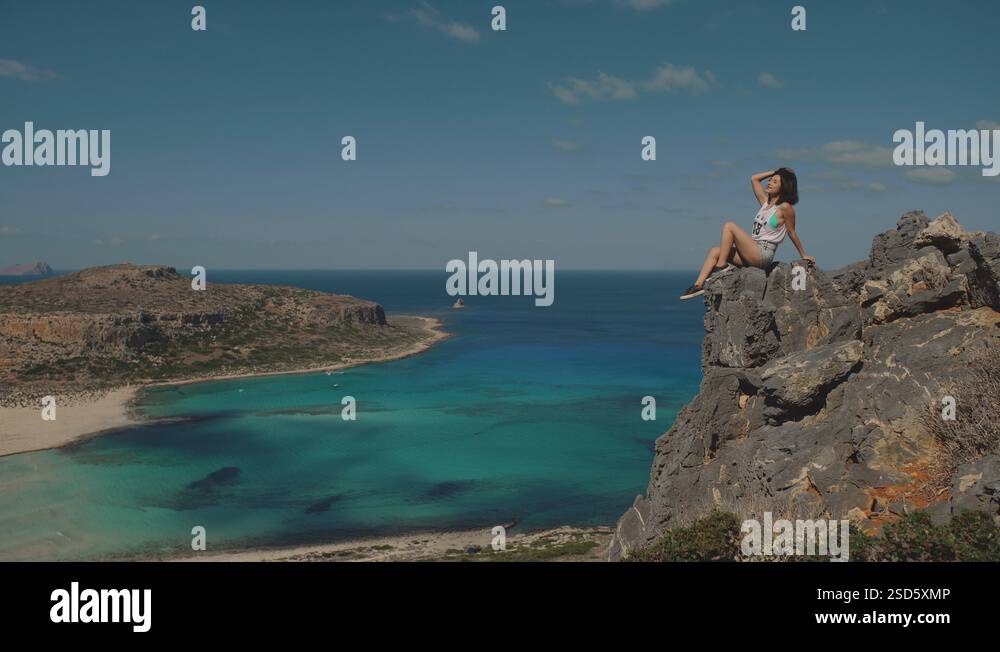 Pretty asian enjoying the vew of blue lagoon on Crete island. Travel ...