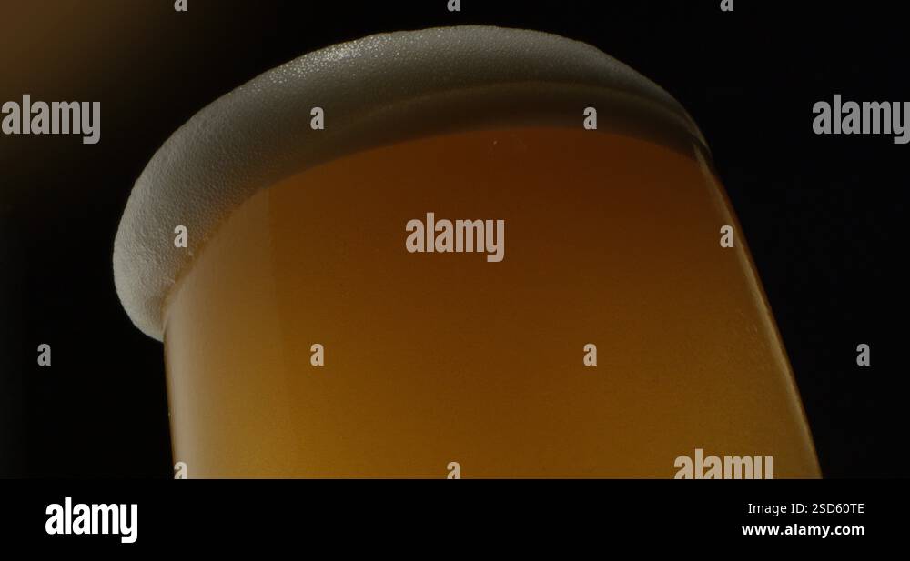 Beer Foam Froth is pouring Out from a Glass Shot on Golden Black ...