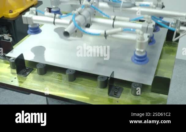 Automated robotic arm system with suction cups and pneumatic tubing used for industrial material ...