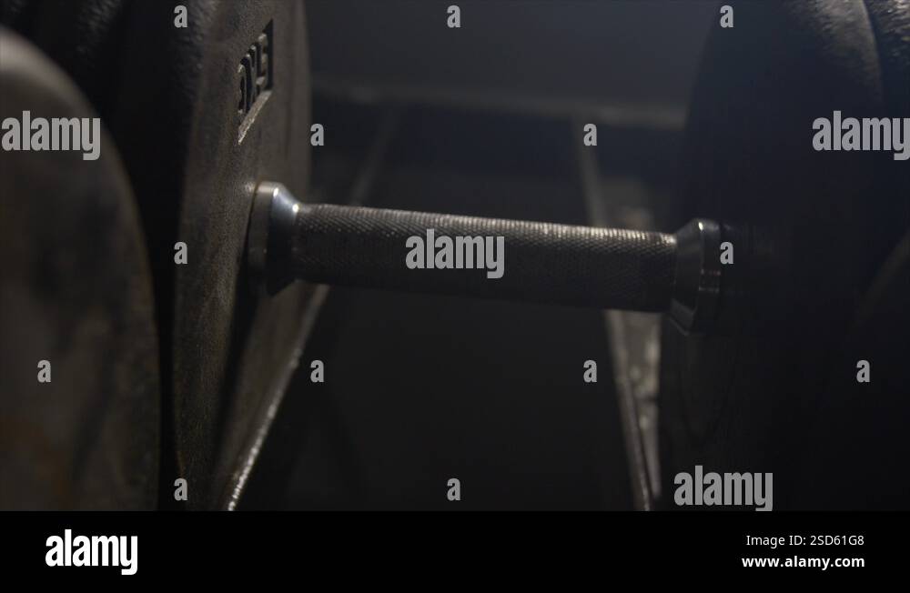 Extreme Close Up Pan Over The Top Of Weights Lined Up On Weight Rack ...
