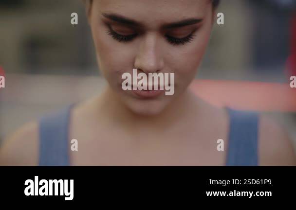 Young woman with closed eyes takes a deep breath and listens to music ...