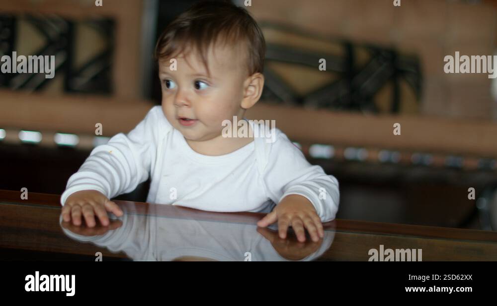 Cute baby hiding under table, infant peeking head smiling and laughing ...