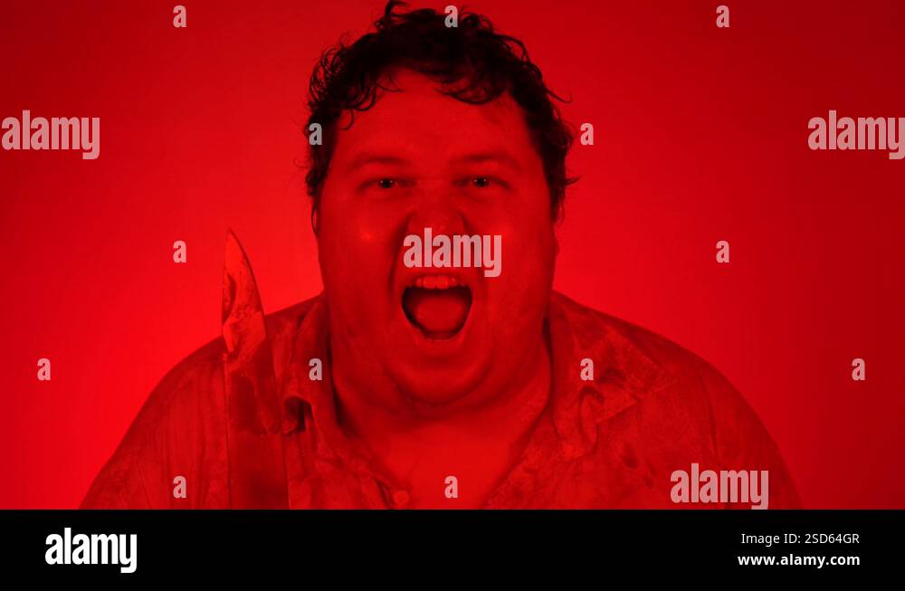 A mad man with knife covered in blood is screaming, ruthless maniac ...