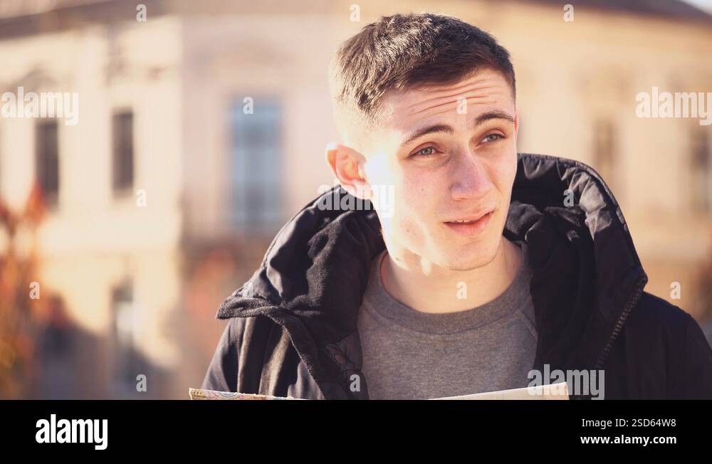 Handsome guy is learning the map. Lost in foreign city. Confused facial ...