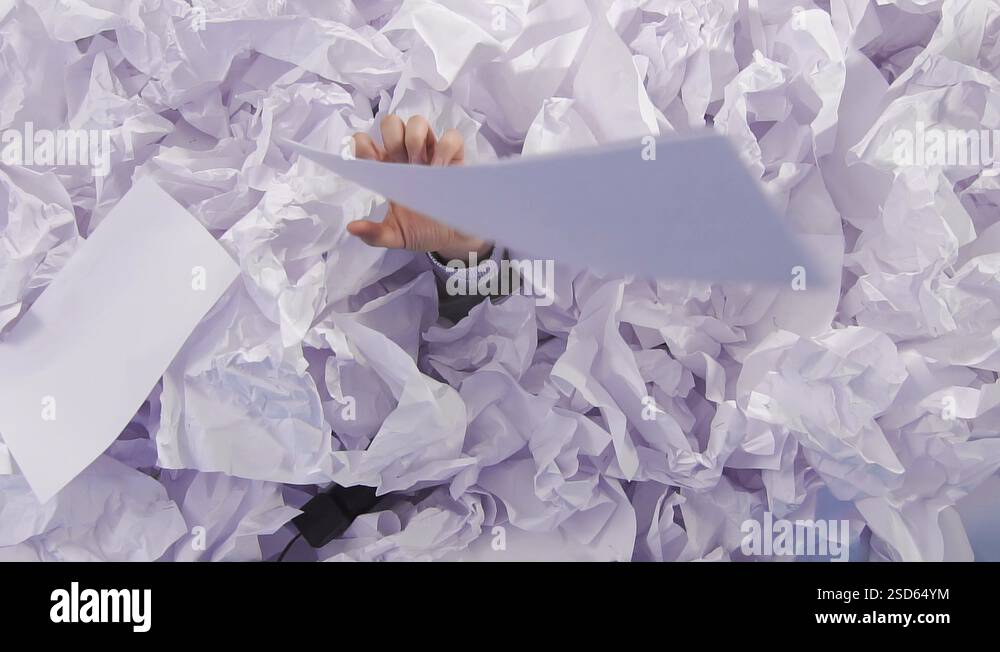 hand reaches out from a large heaps of crumpled paper the view from the ...