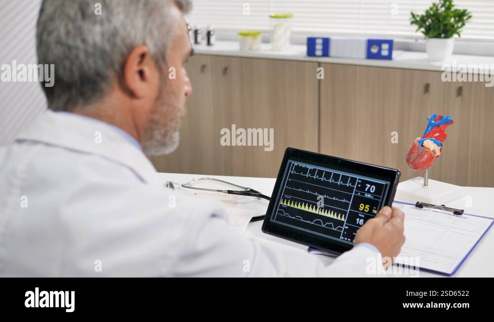 male doctor checks real time ecg data on the tablet Stock Video Footage ...