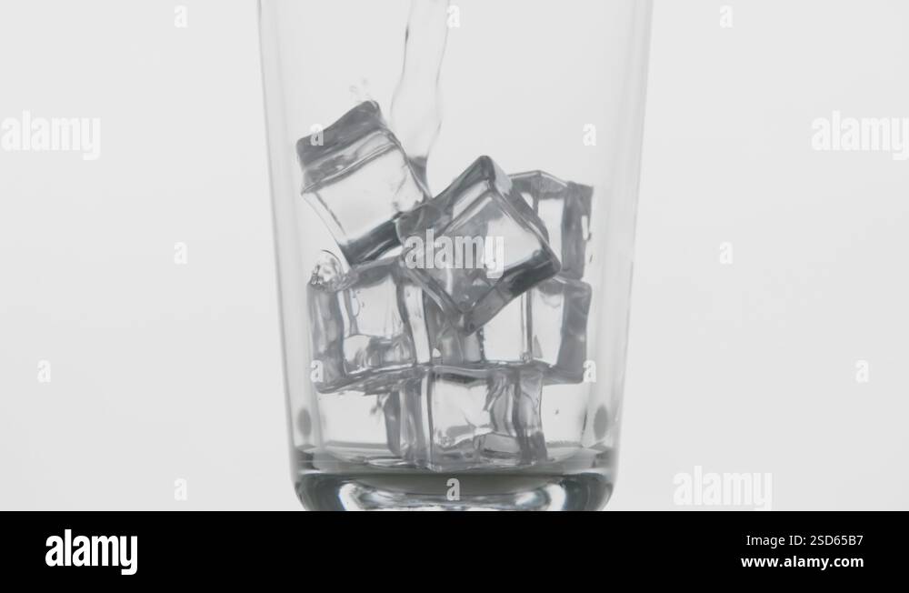 Close-up pouring fizzy drink. Glass full of cold sparkling water with ice cubes Stock Video ...