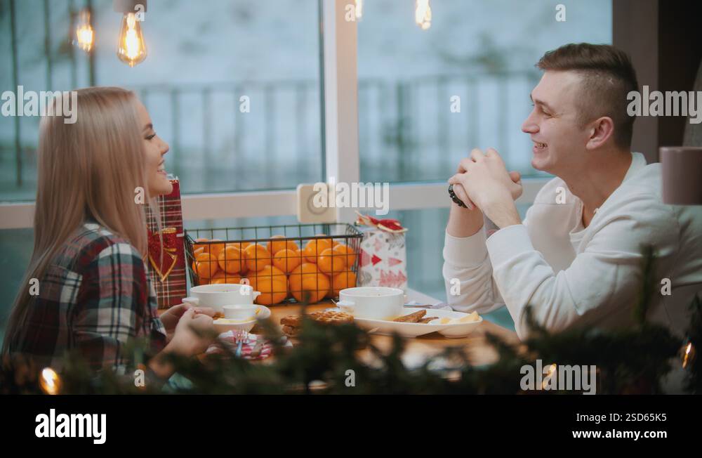 A couple in cafe having a lunch and talking to each other - waiter ...