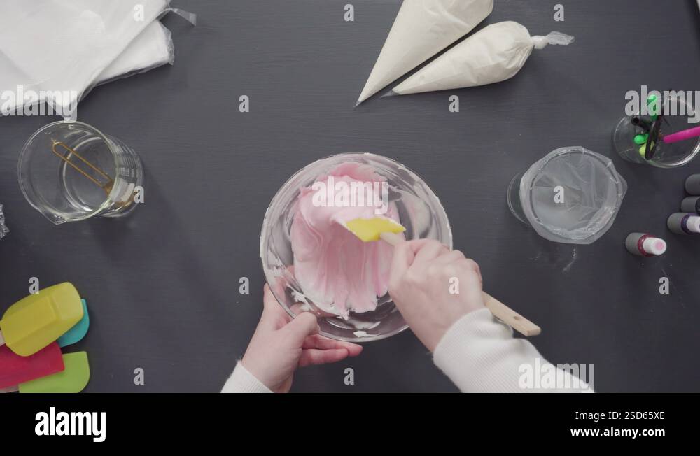 Mixing in food coloring into the royal icing to decorate sugar cookies ...