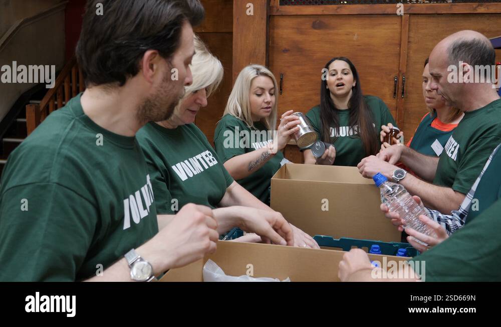Food Bank team of volunteers sorting Groceries into boxes at a Shelter ...