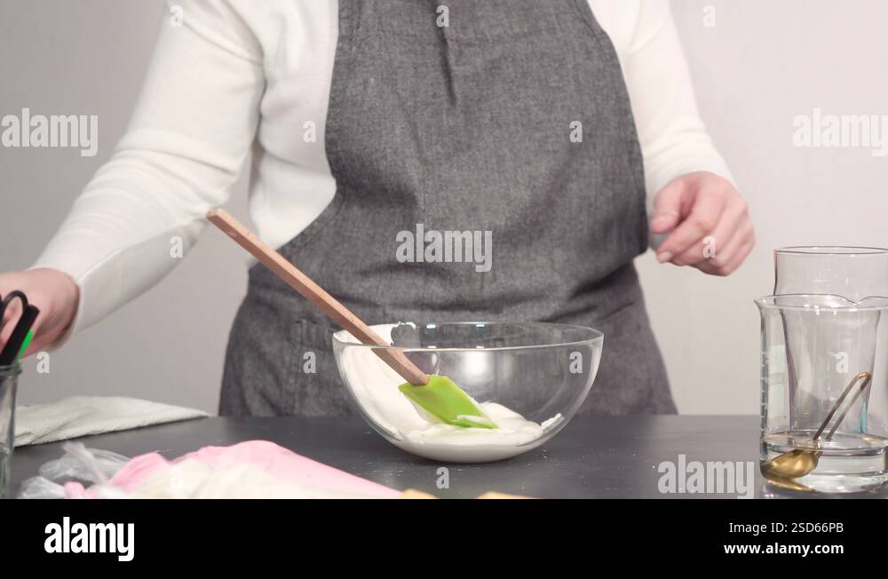 Mixing in food coloring into the royal icing to decorate sugar cookies ...