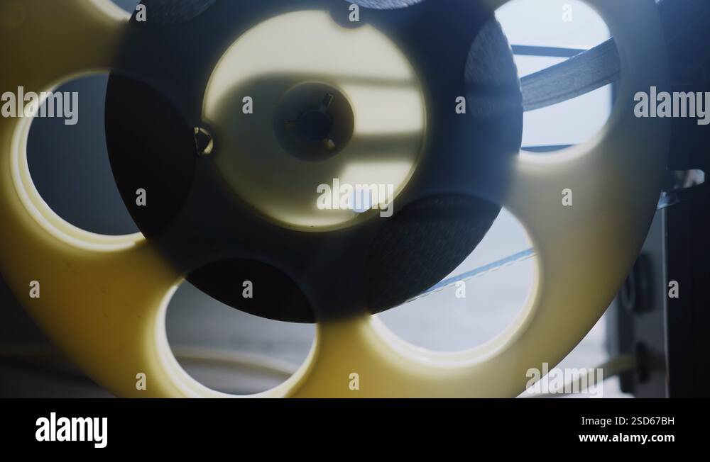 Reel with a film rotating and light rays. Old movie projector Stock ...