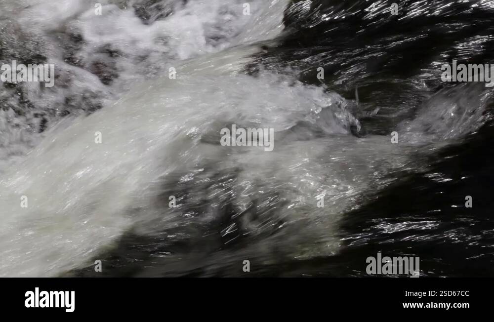 Water pouring over rocks in an upland stream Stock Video Footage - Alamy