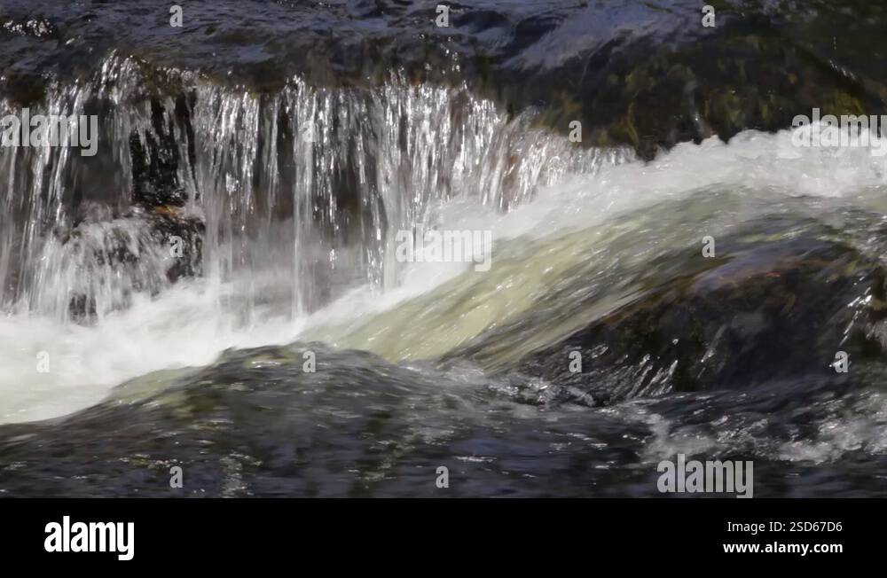 Water pouring over rocks in an upland stream Stock Video Footage - Alamy