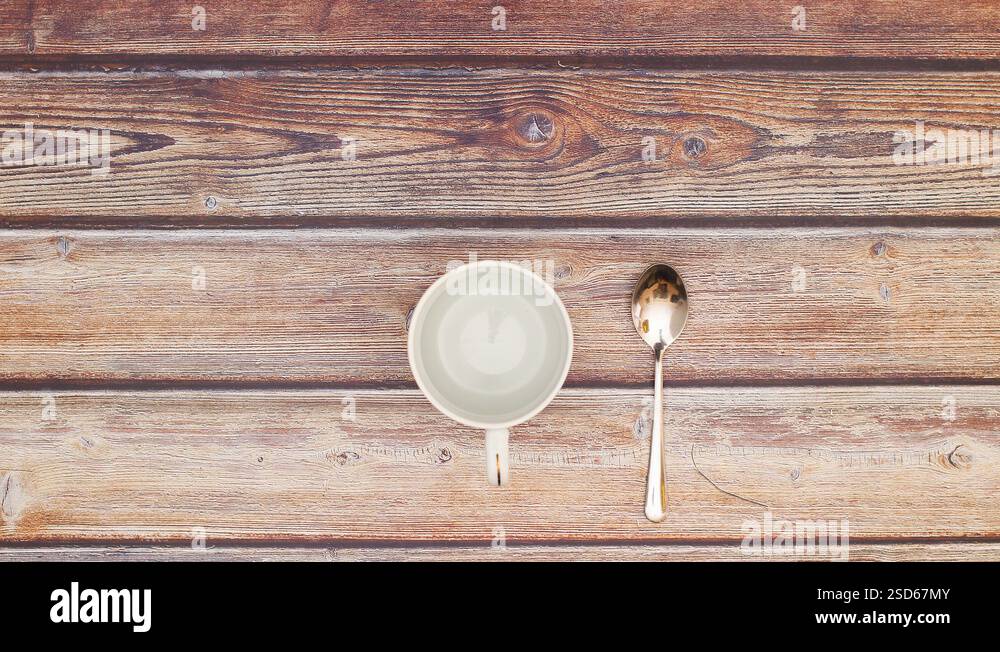 Making tea in white ceramic cup with hot water and metal spoon - Stop ...