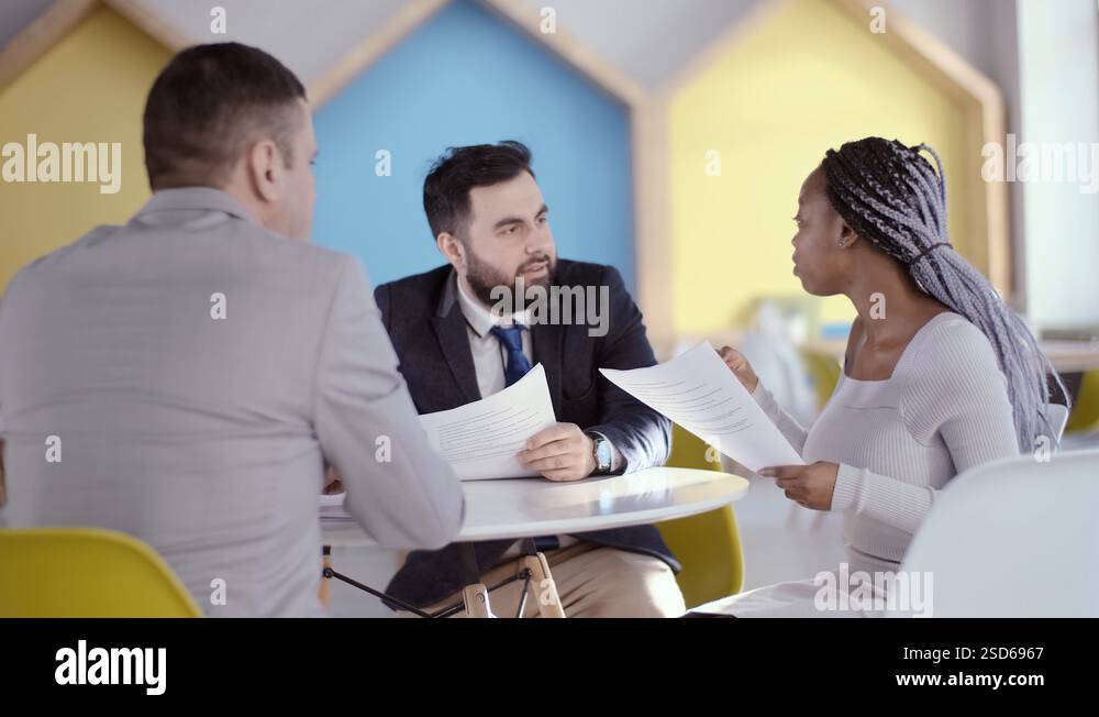 Young african american business woman at the negotiating table explains ...