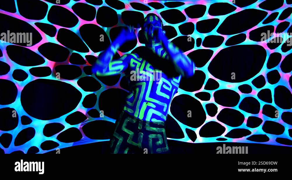 Neon body art, a man is glowing in the dark and dancing, bright ...