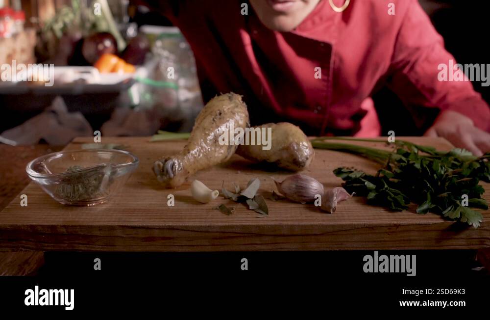 Young woman chef seasoning chicken legs on a wooden cutting board Stock ...